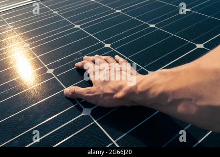 Man hand touching solar panels on sun Stock Photo - Alamy