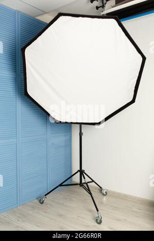 Studio flash with soft box standing in the corner of the Studio. Side ...