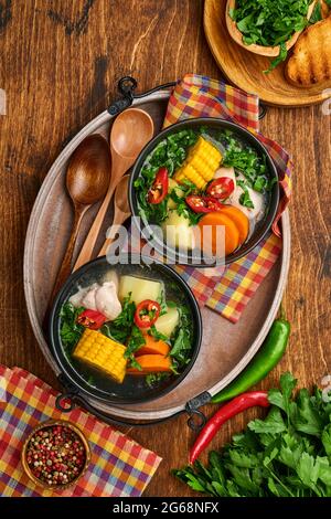 Chilean meat soup with pampkin, corn, fresh coriander and potatoes on ...
