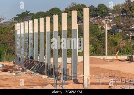 The concrete foundations for the columns of a factory building are ...