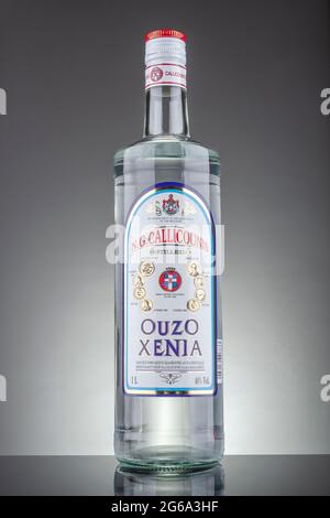 Bottle of Xenia ouzo isolated on gradient background. Ouzo is dry anise ...