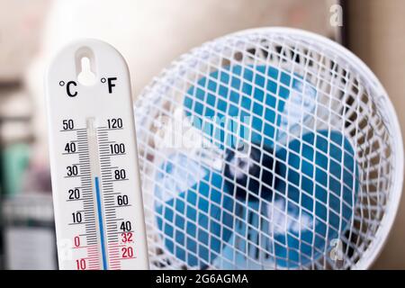 Small fan and room mercury thermometer close up Stock Photo - Alamy