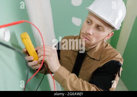 electrician measuring voltage in distribution board closeup Stock Photo ...
