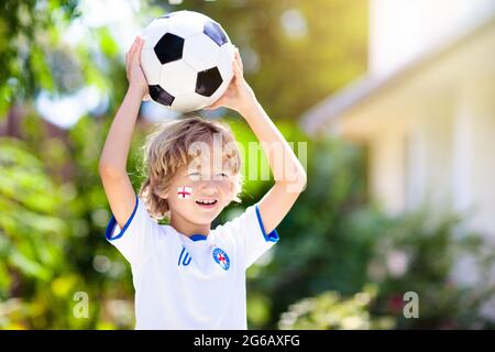 Boy in soccer jersey cheering Stock Photo - Alamy