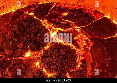 The surface of a hot liquid slag in a metallurgical ladle. Thick crust ...