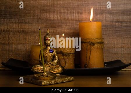 Buddha craft in meditation posture with candle Stock Photo - Alamy