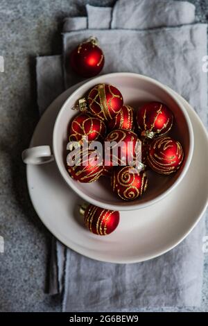 Christmas background with napkin, red baubles, ribbon and a candy cane ...