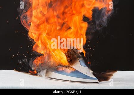 House fire caused by faulty clothes iron. Overheating electrical home ...