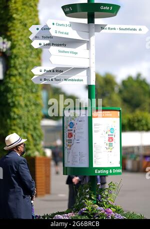 A spectator checks the map by gate 5 ahead of day seven of Wimbledon at ...