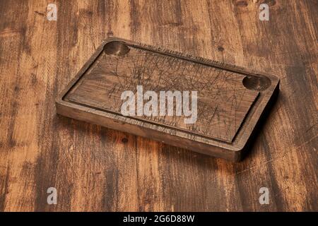 From above scratched chopping board with sealed cans with preserved ...