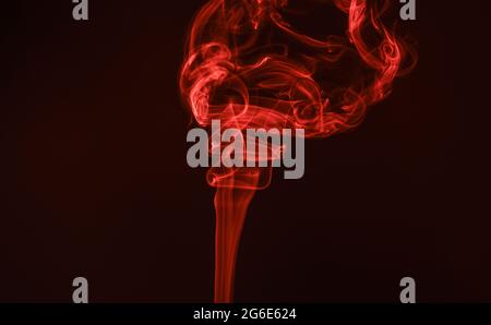 Wisp of red smoke spiraled abstract steaming maroon background, steam ...