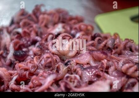 Pickled octopuses, scattering, heap. Ready-made seafood Stock Photo - Alamy