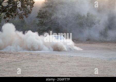 Drifting a car raises clouds of dust Stock Photo - Alamy