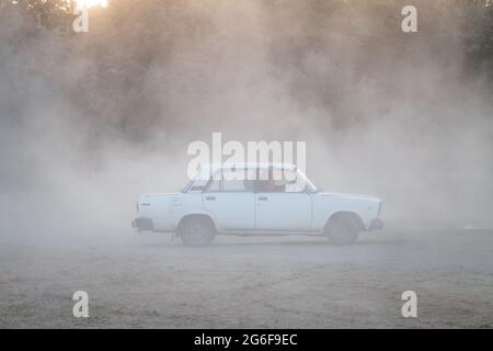 Drifting a car raises clouds of dust Stock Photo - Alamy