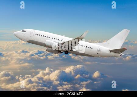Airplane flies gaining height above ground clear sky Stock Photo - Alamy