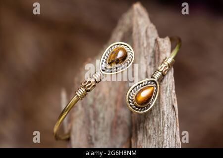 Brass metal mineral stone detail elegant bracelet on natural background ...