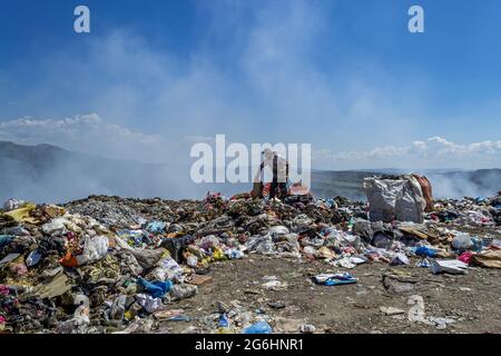 Shot of workers sorting garbage for recycling in a trash dump Stock ...