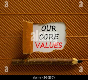 Our core values symbol. Words 'Our core values' appearing behind torn ...