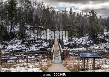 Swinging bridge crossing the St. Louis River in Jay Cooke State Park ...