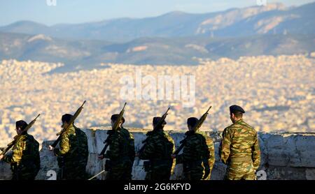 Greek soldiers marching down from the Acropolis after the Greek flag ...