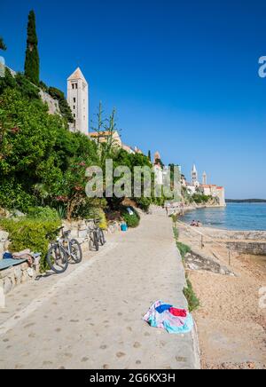 Historic town of Rab towers and beach walkway view Stock Photo - Alamy