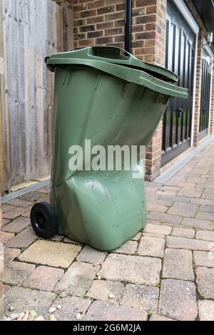 Damaged Council Green Recycle Bin Stock Photo - Alamy