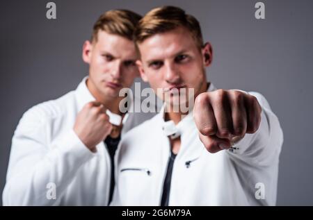 two cousin show fist. young confident brothers. confident fashion ...