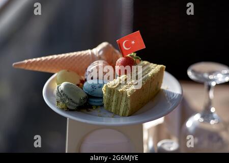 Healthy zucchini cake, ice cream, macaroons and Turkish flag on a white ...