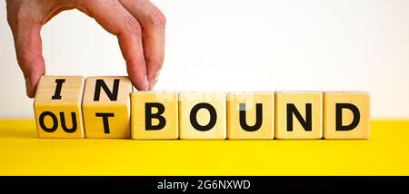 Inbound or outbound symbol. Businessman turns wooden cubes and changes ...