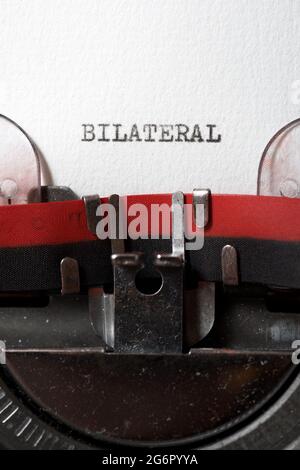 The word bilateral written with a typewriter Stock Photo - Alamy
