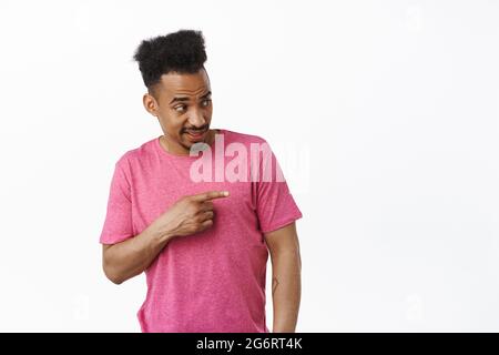 Portrait of skeptical and judgemental african-american guy in beanie ...