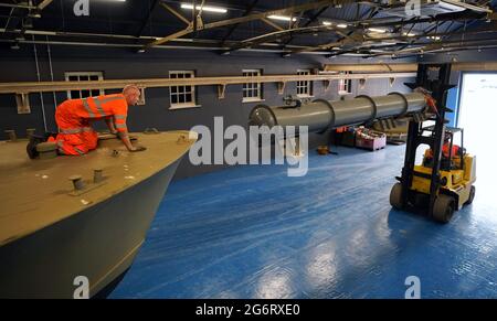 A torpedo tube is lifted onto the historic Second World War Motor ...