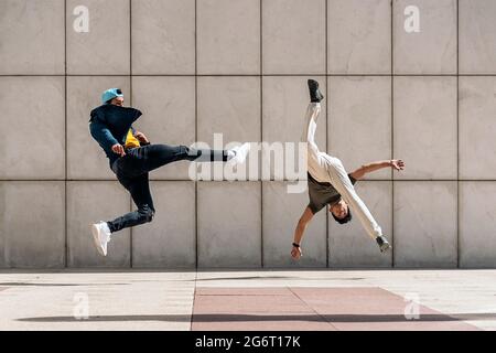 Amazing young men dancing break dance together in the city and having ...