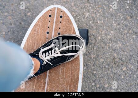 Beautiful skater practicing riding skate board on street with ...