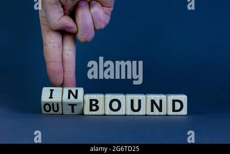 Inbound or outbound symbol. Businessman turns wooden cubes and changes ...
