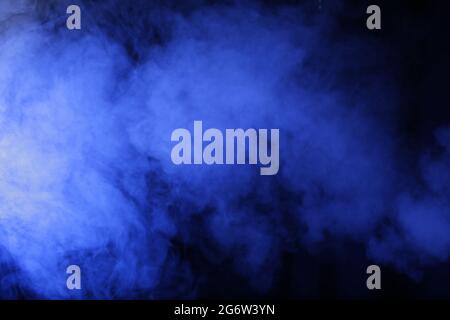 Artificial magic light illuminates smoke isolated on dark background ...