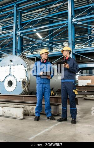 experts during quality control in the interior of a factory Stock Photo ...