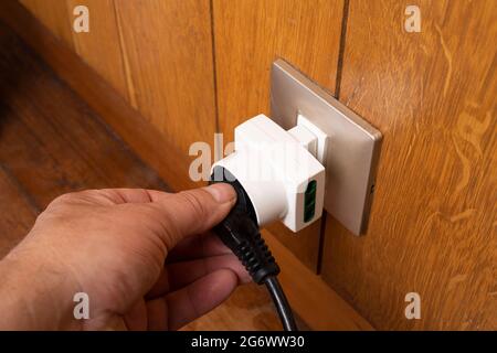 Remove the power electric plug socket from the outlet box on the wooden ...