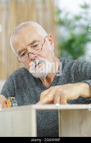 a senior man doing diy Stock Photo - Alamy