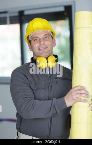 Builder wearing ear protection Stock Photo - Alamy