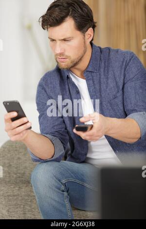 Man trying to fix broken tv Stock Photo - Alamy