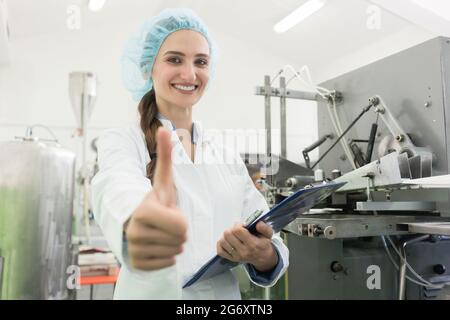 Female lab technician showing thumbs up sign in a laboratory Stock ...