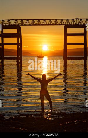 Pictured: Natasha Jenkins in the sea during sunrise as seen through the ...