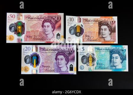 Bank of England complete collection of new polymer banknotes on a black ...