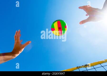 hands receiving flying colour beach volley ball Stock Photo - Alamy