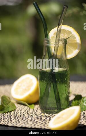 Vertical shot of refreshing chlorophyll drink mixed with lemon and mint ...
