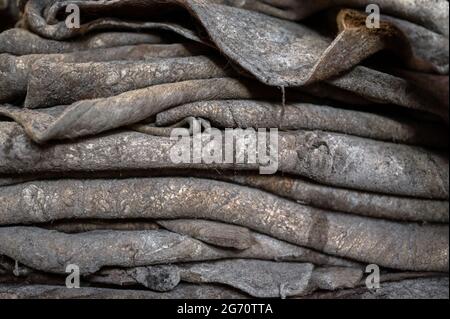 Raw salted cow skins are piled up Stock Photo - Alamy