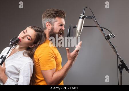 Couple singing. Coupl in recording studio. Music performance vocal ...