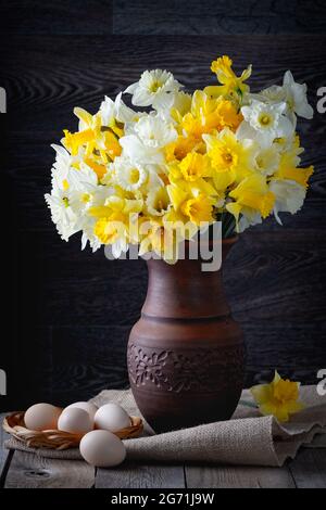 Vase with beautiful daffodils on dark background Stock Photo - Alamy