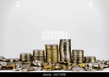 Seven stacks of golden coins with different heights arranged in growing ...